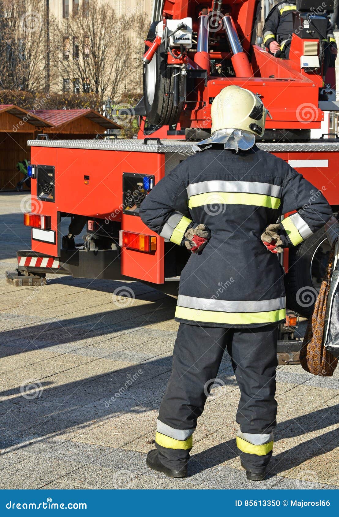 Firefighter Stands Next To a Crane Stock Photo - Image of occupation ...