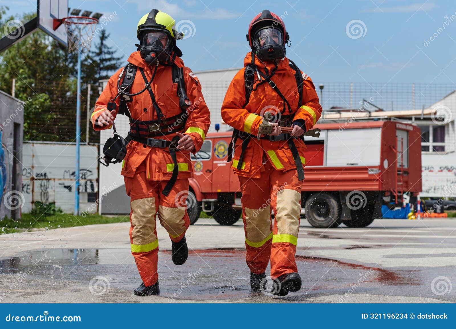 Firefighter Team Training with Various Tools in Professional Gear Stock ...