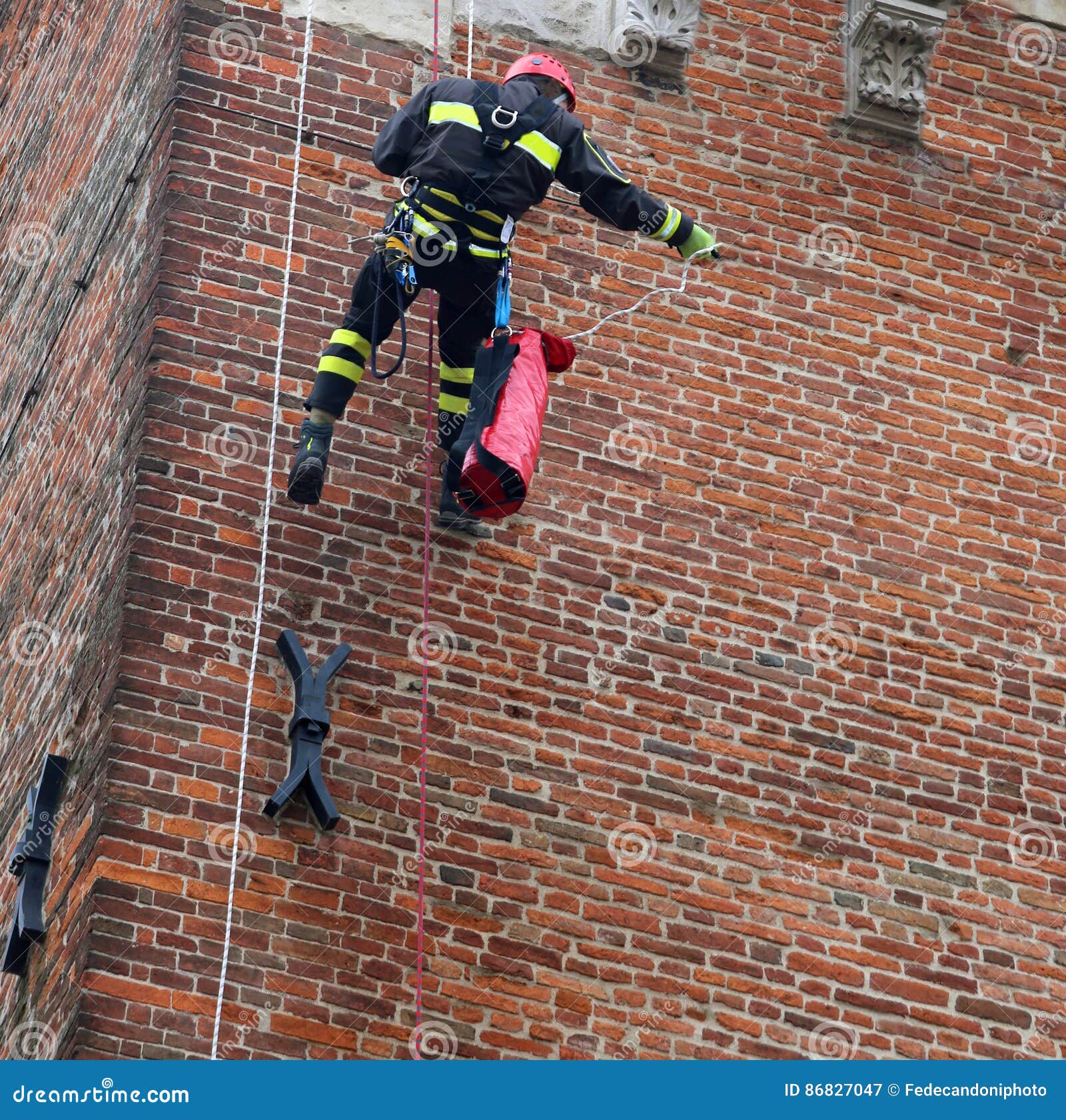 Firefighter during a Training Exercise Climbing on Old Brick Med Stock ...