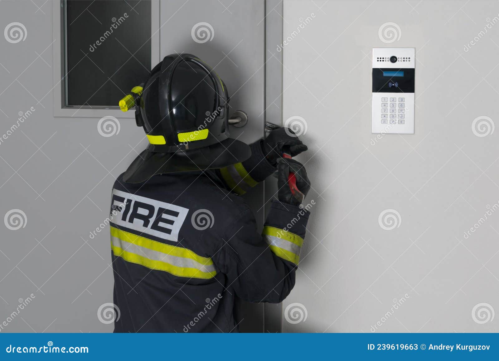 A Firefighter Tries To Open the Iron Front Door with a Crowbar Stock ...