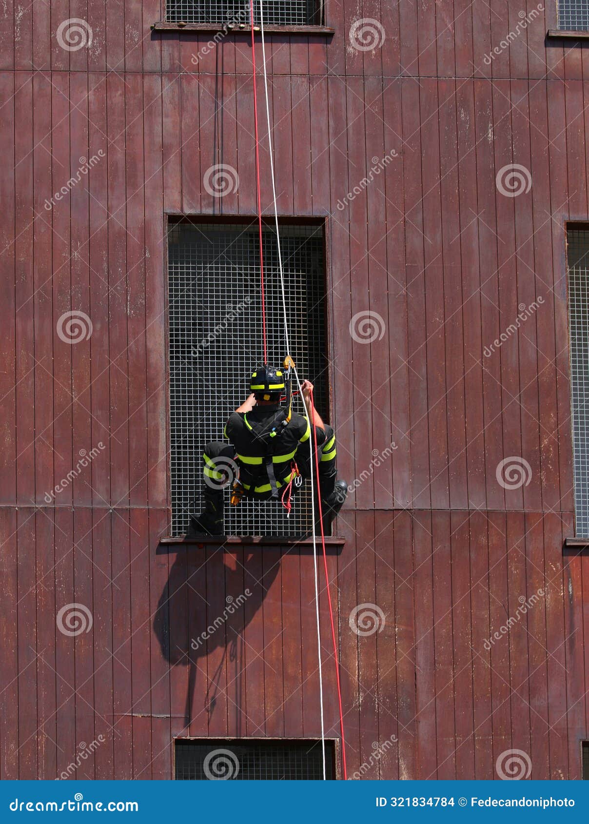 Firefighter in Uniform Rappelling Down Building during Fire Station ...