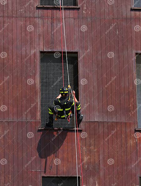 Firefighter in Uniform Rappelling Down Building during Fire Station ...