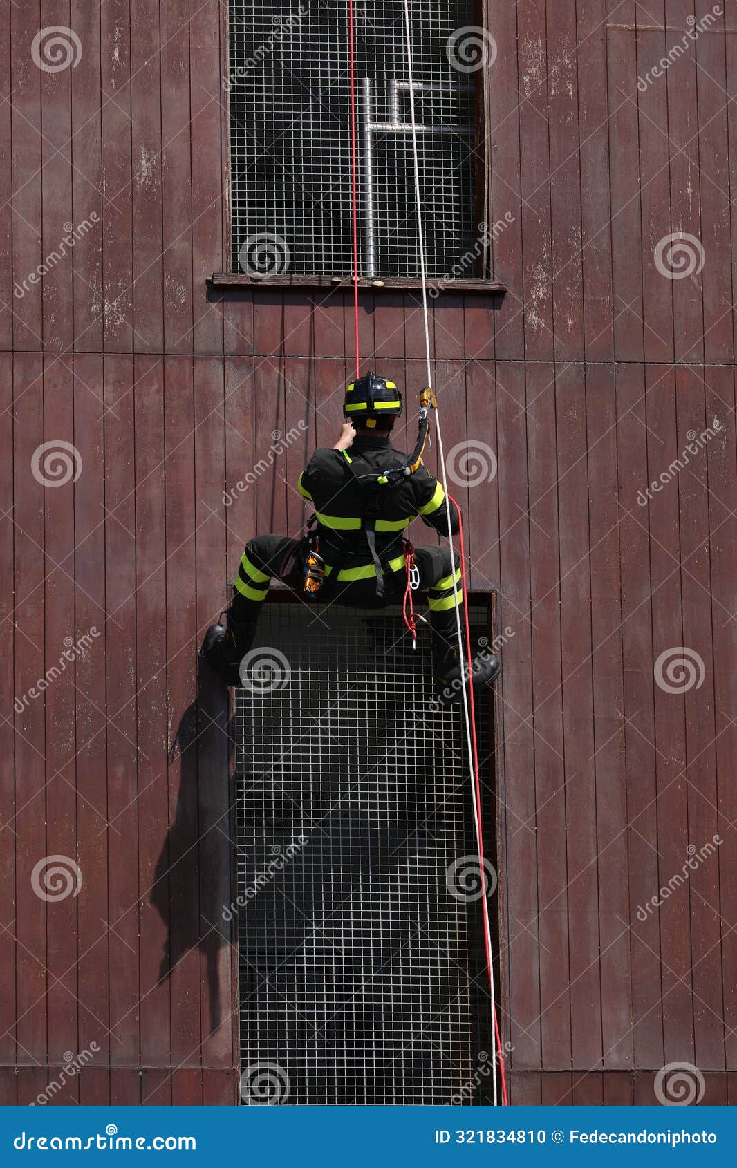 Firefighter and Uniform Rappelling Down Building during Training ...
