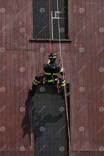 Firefighter and Uniform Rappelling Down Building during Training ...