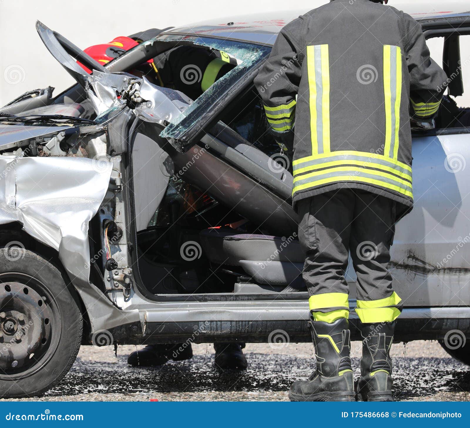 Firefighter with Uniofmr and Helmet and a Broken Car Stock Photo ...