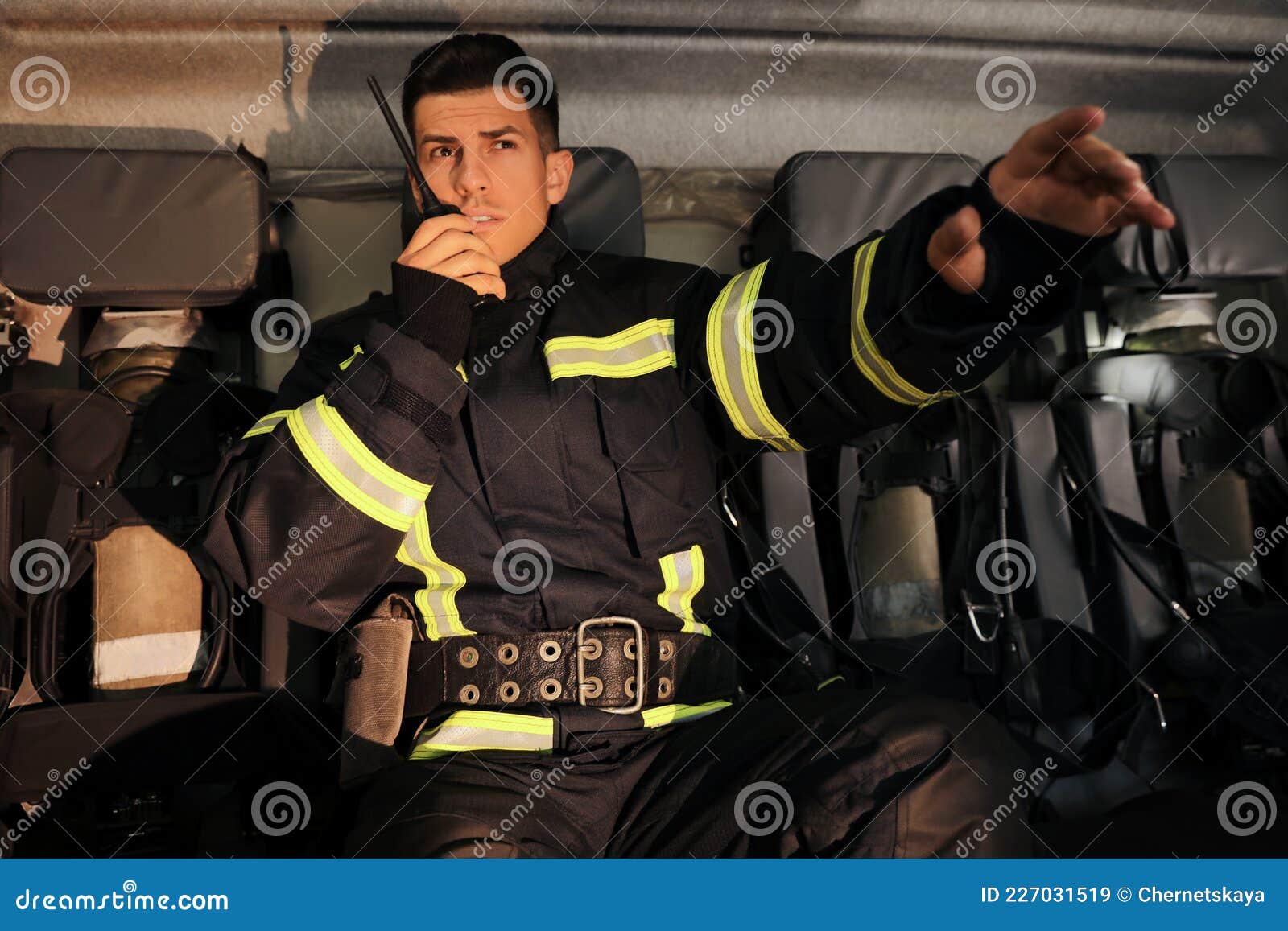 Firefighter Using Portable Radio Set in Fire Truck Stock Image - Image ...