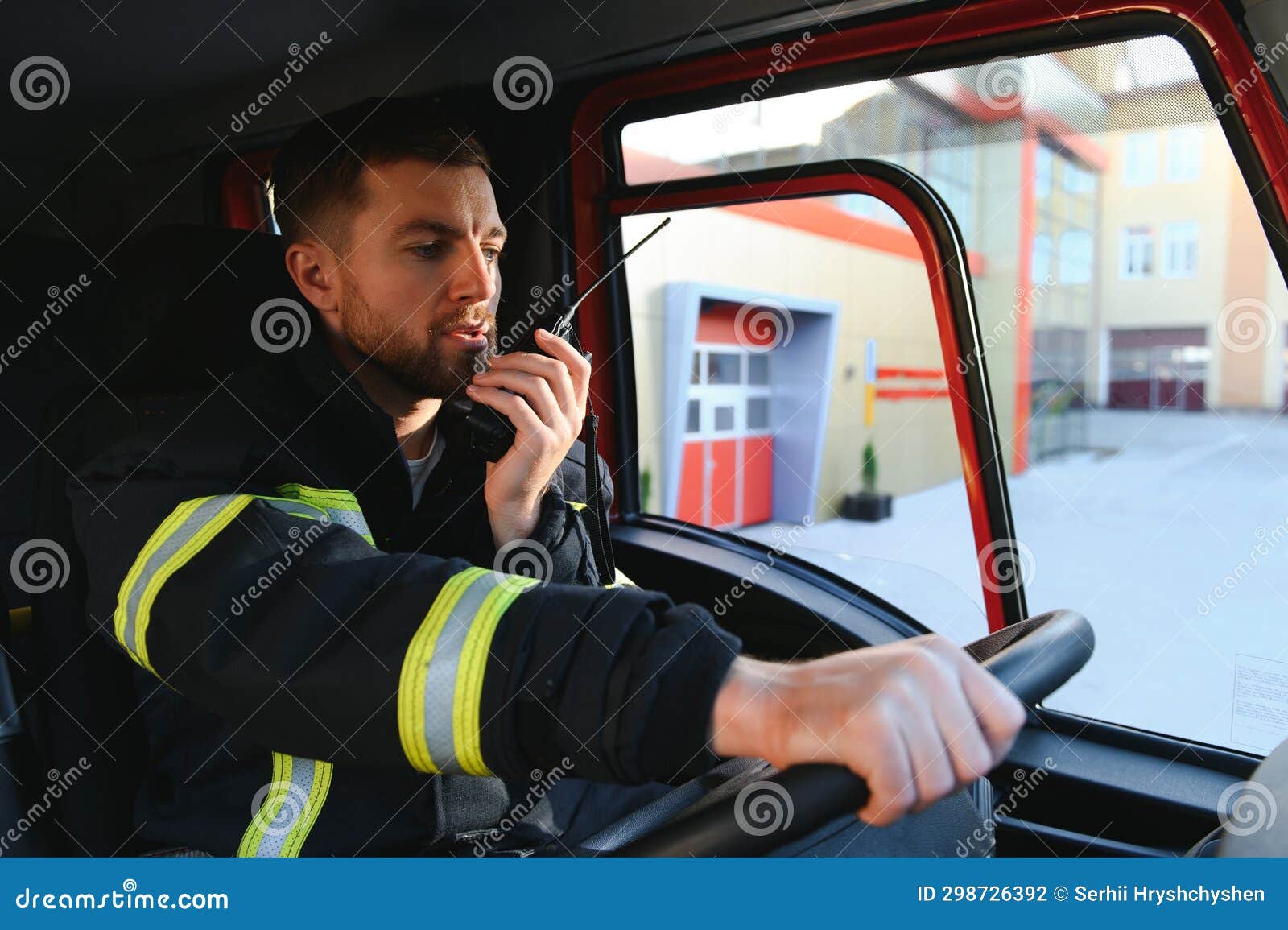Firefighter Using Radio Set while Driving Fire Truck Stock Photo ...