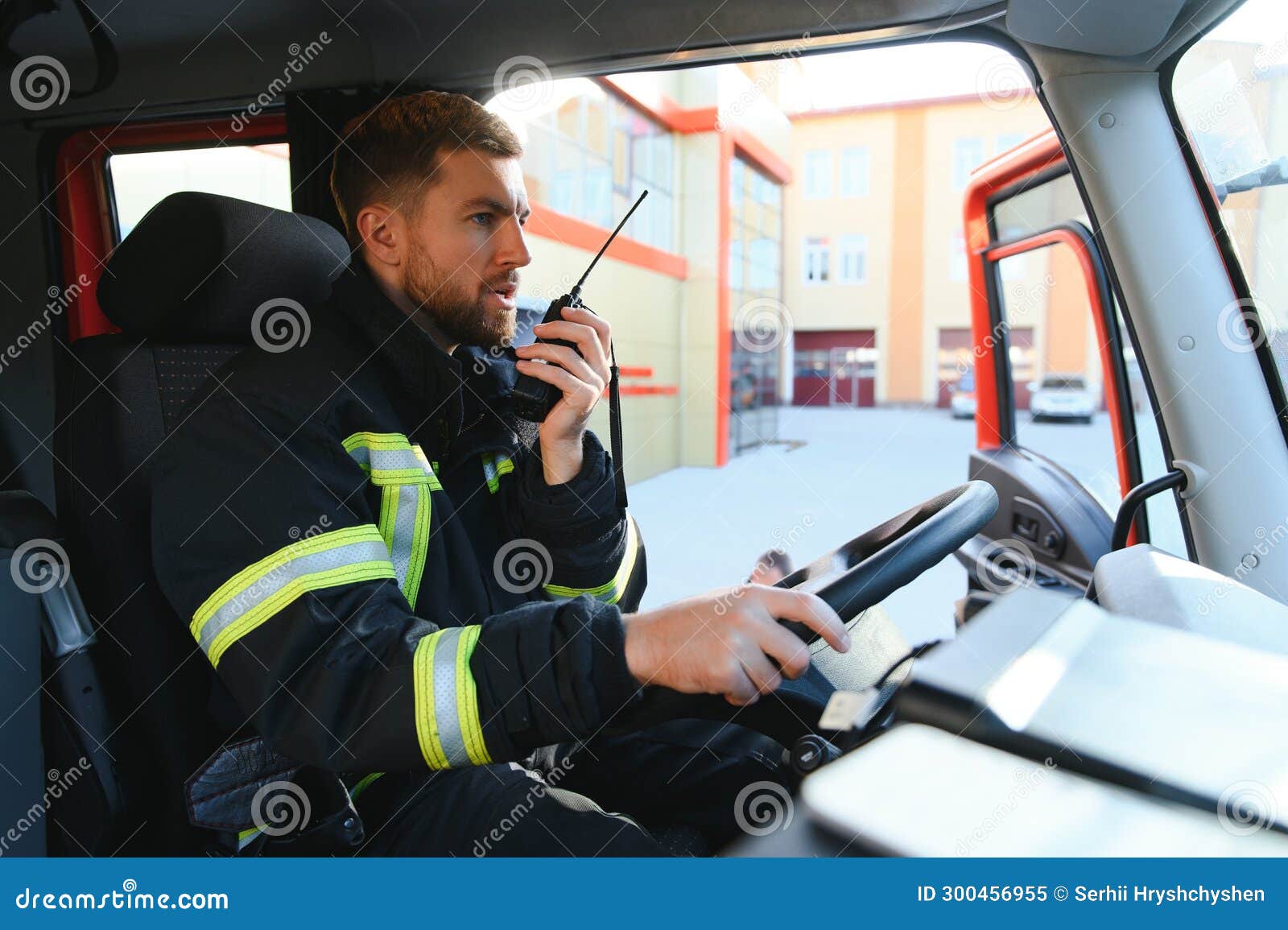 Firefighter Using Radio Set while Driving Fire Truck Stock Image ...