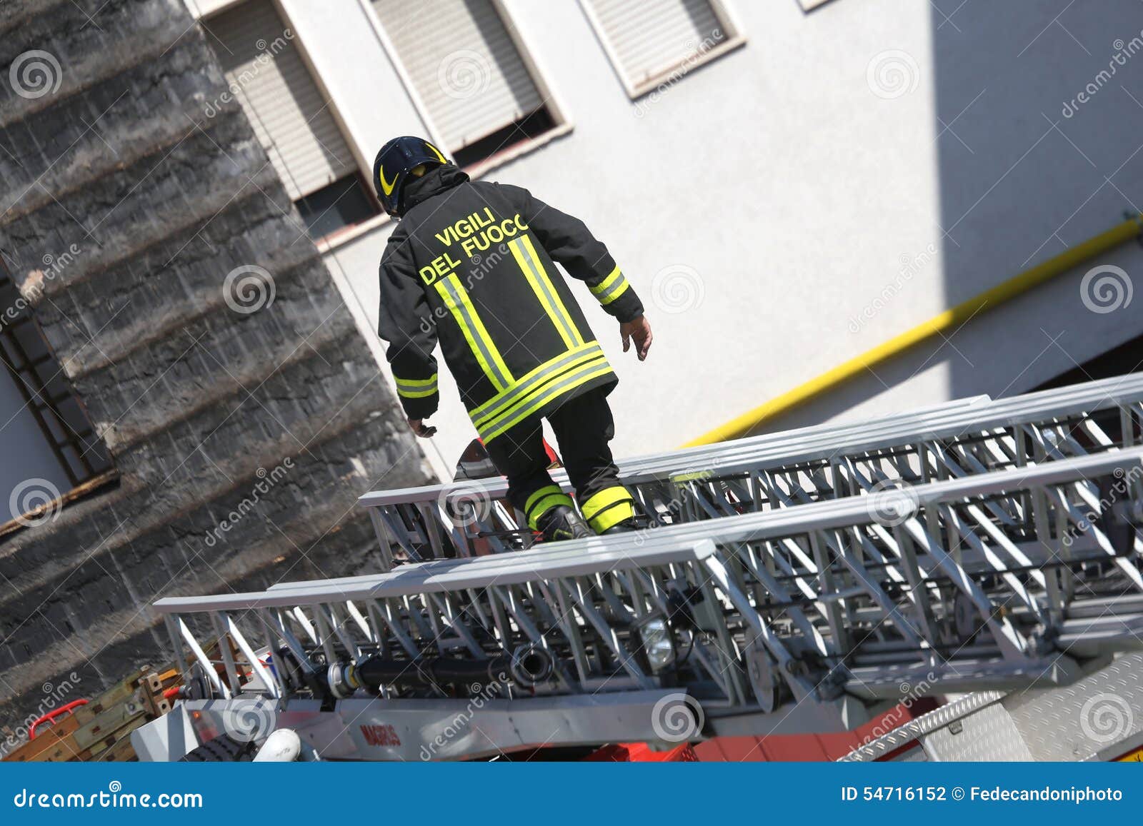 Firefighter Walking on Extended Ladder of Firetrucks during the ...