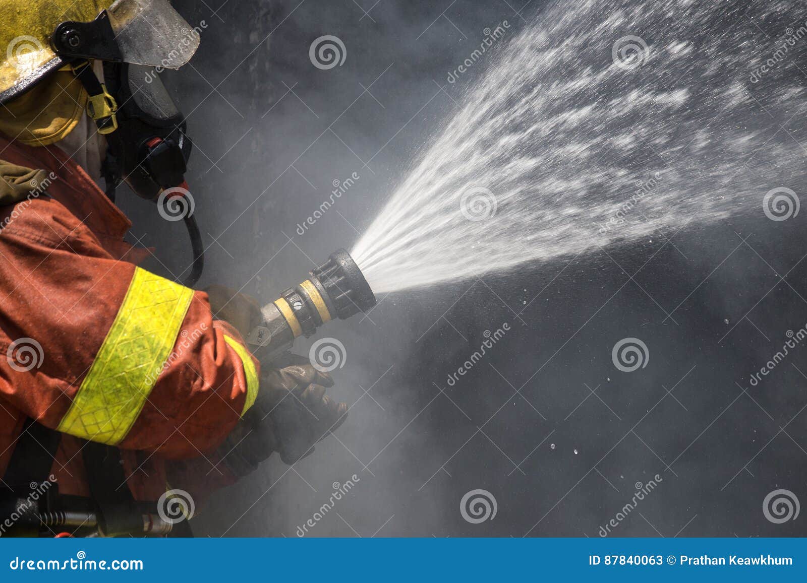 Firefighter Water Spray by High Pressure Fire Hose Stock Image - Image ...