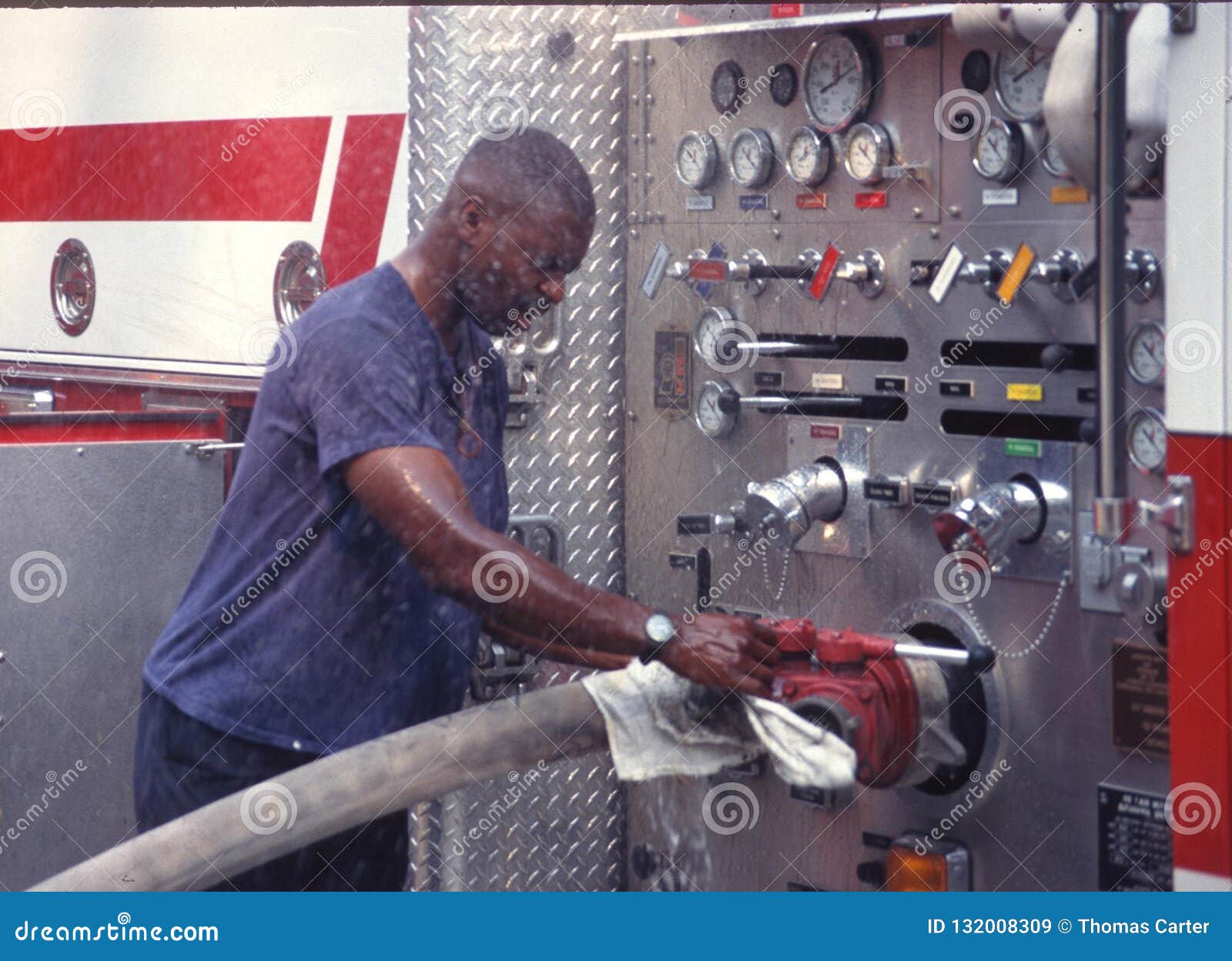 A Firefighter Works the Pumps on a Fire Truck Editorial Stock Image ...