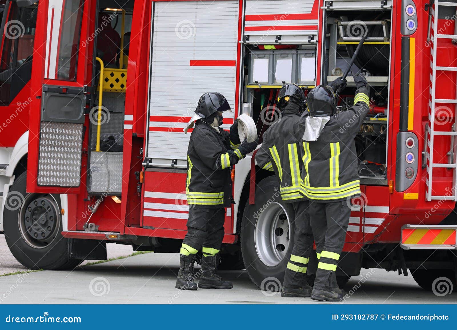 Firefighters in Action with the Fire Truck during the Emergency with ...