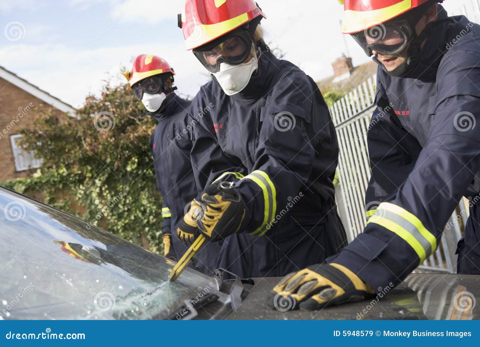 Firefighters Breaking A Car Windscreen To Help A Car Crash Victim ...