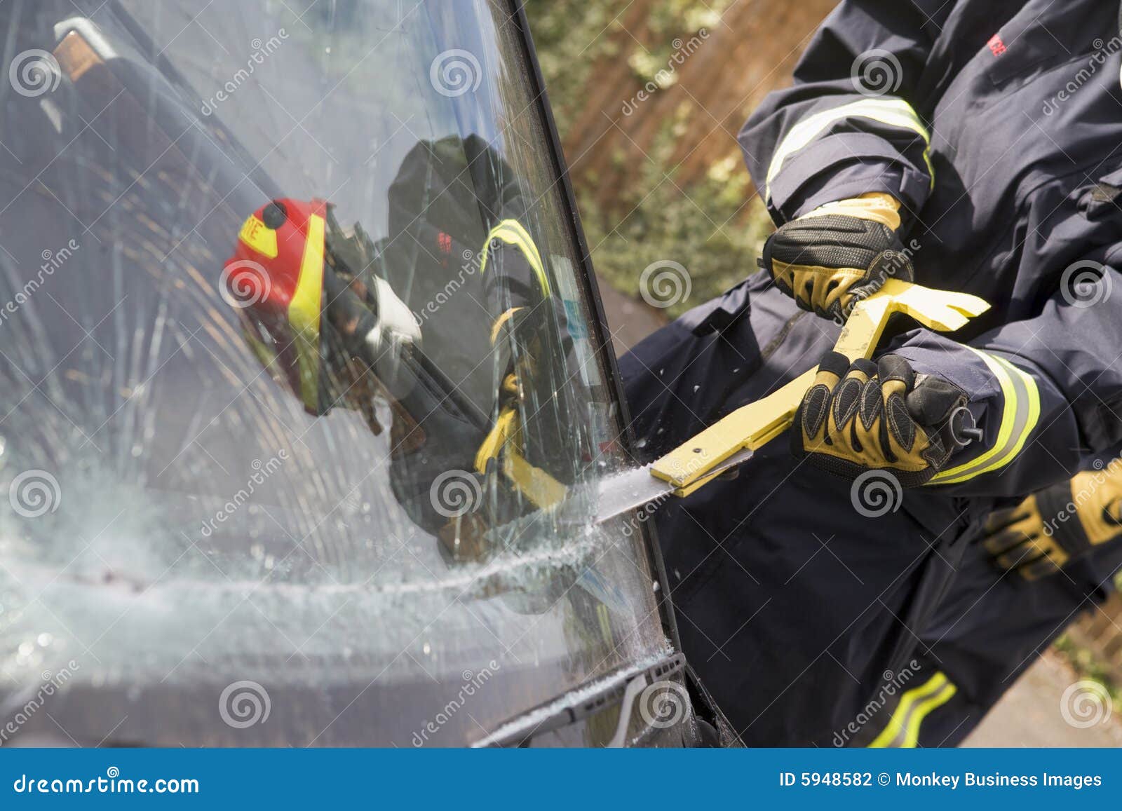Firefighters Breaking A Car Windscreen To Help A Car Crash Victim ...