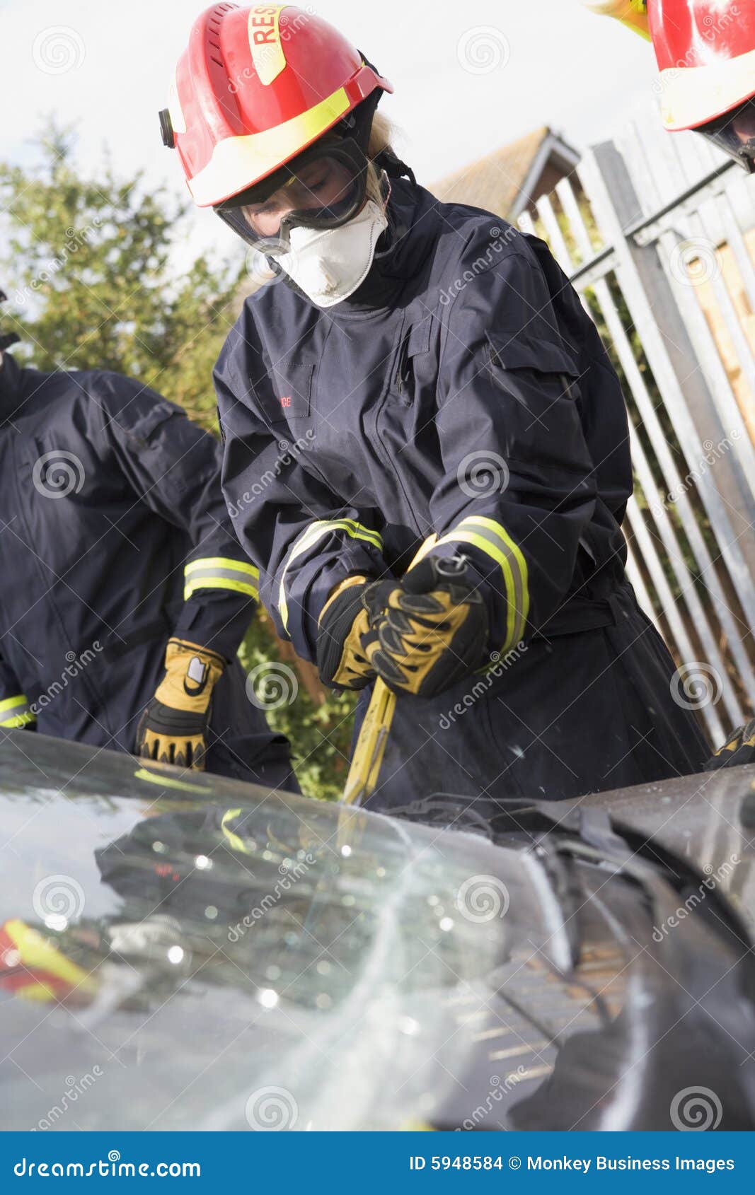 Firefighters Breaking a Car Windscreen Stock Photo - Image of suit ...