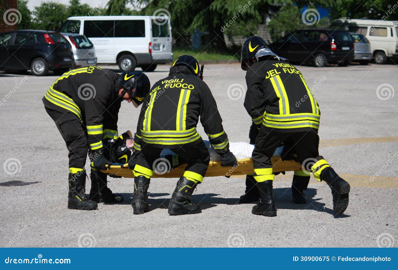 Firefighters Carry a Stretcher with Serious Injuries after the a ...