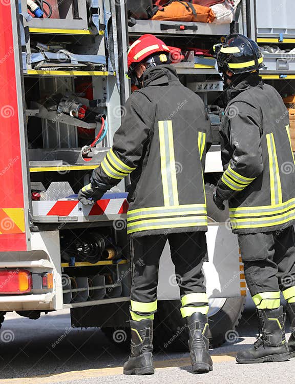Firefighters with Uniform during an Emergency Response are Taking ...