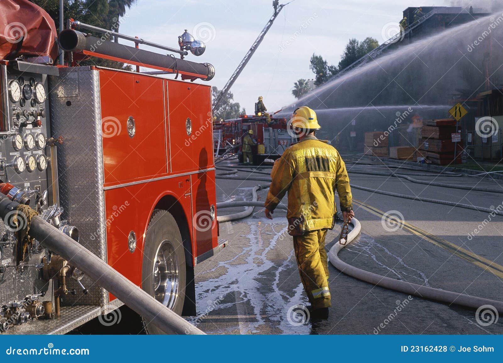 Firefighters and engines editorial stock photo. Image of dousing - 23162428