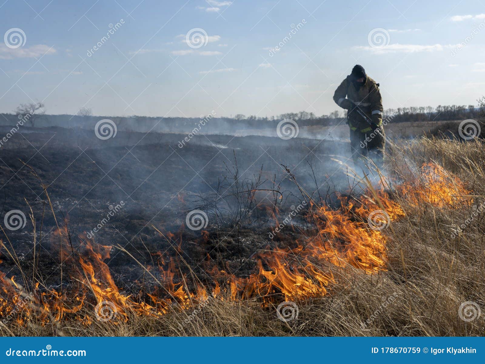Firefighters Extinguish the Flames of Burning Grass Stock Image - Image ...