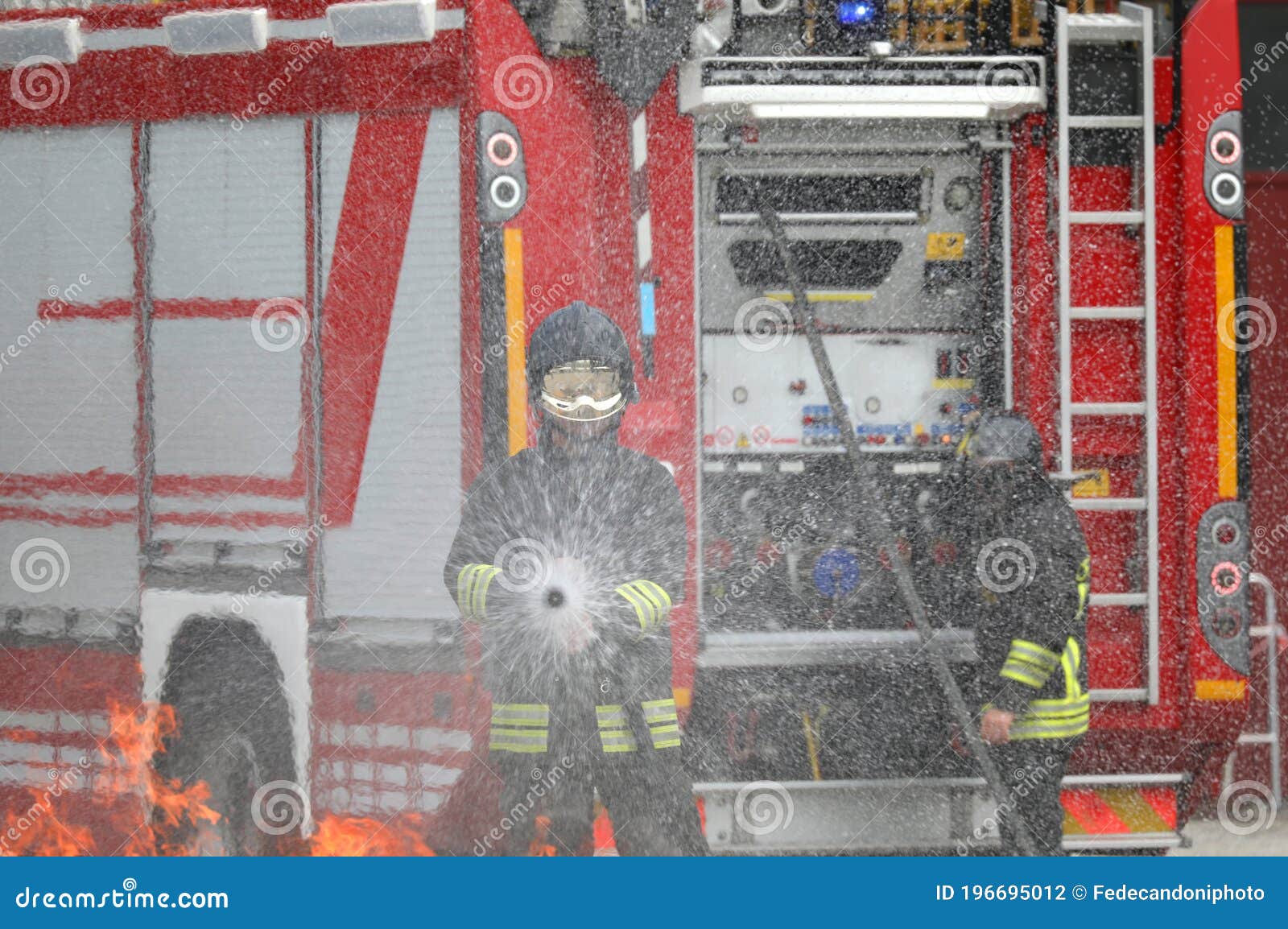 Firefighters Extinguishing a Fire Using an Hydrant Stock Photo - Image ...