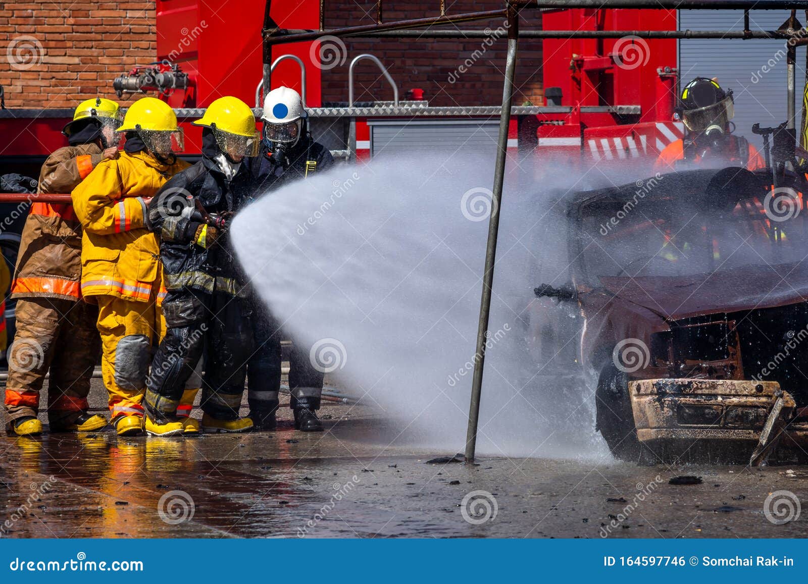 Firefighters Fighting Fire during Training with High Pressure Water To ...