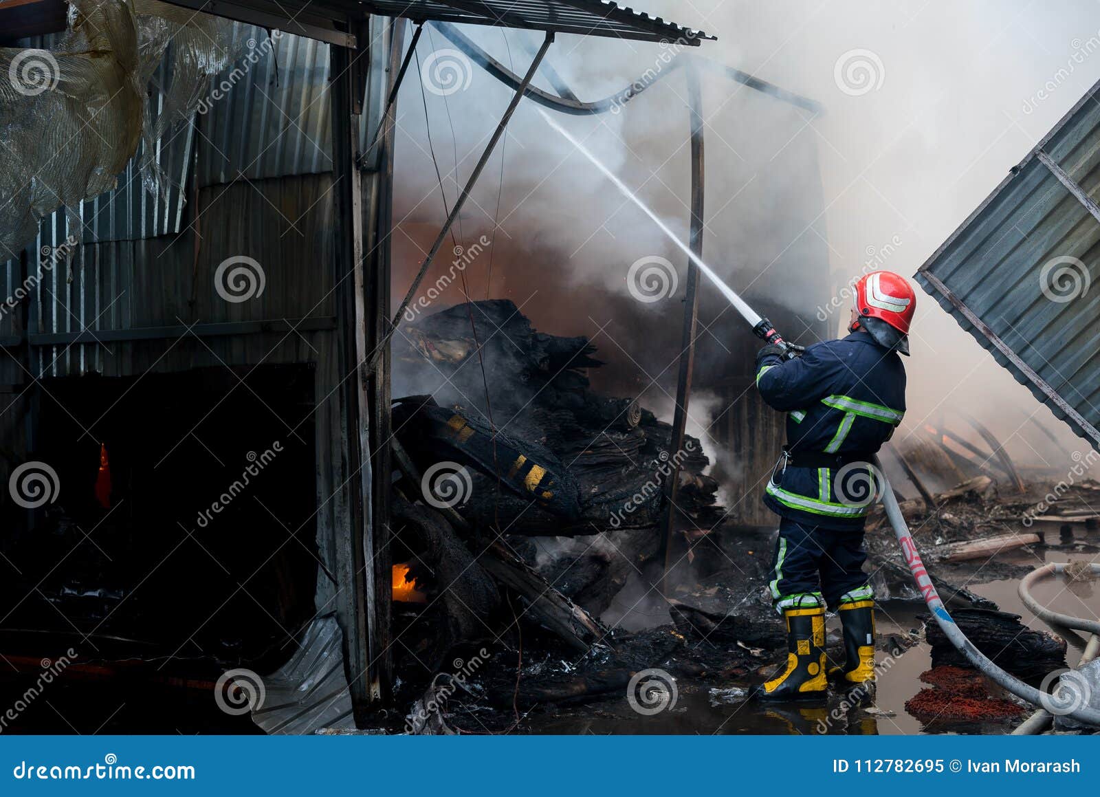 Firefighters on Fire. Fireman Extinguishes the Fire with Water ...