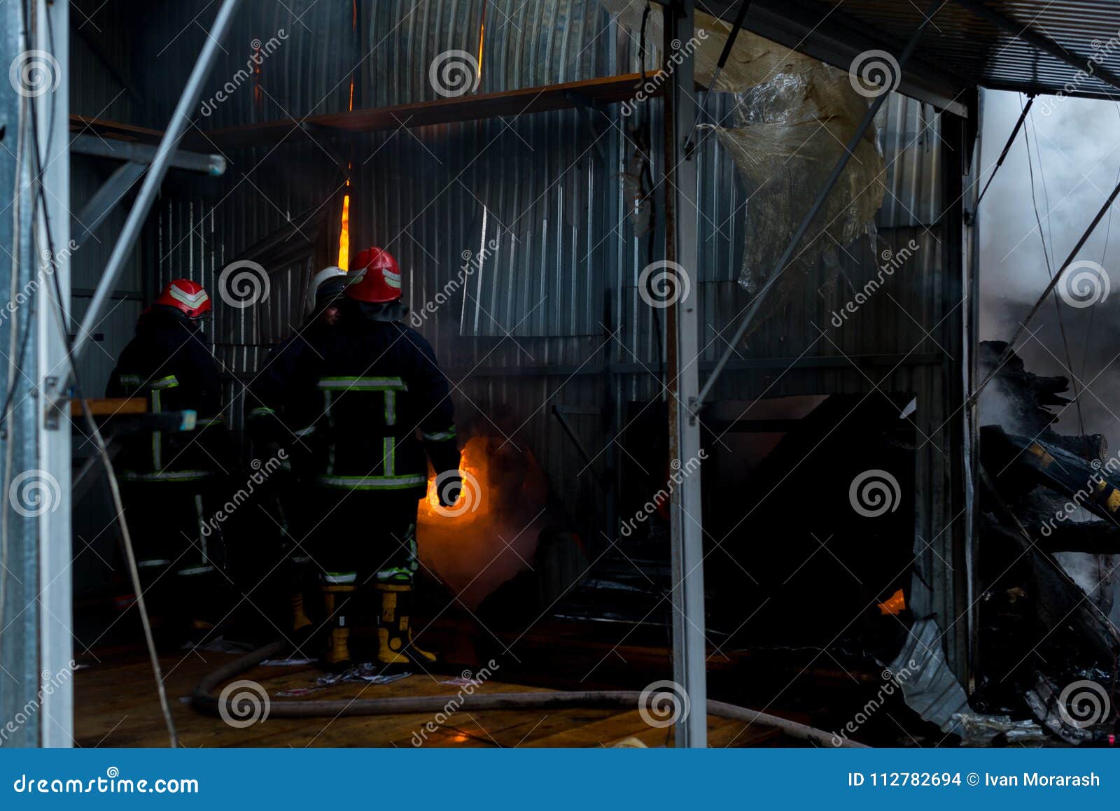 Firefighters on Fire. Two Firemans Speaking when Third Extinguishes the ...