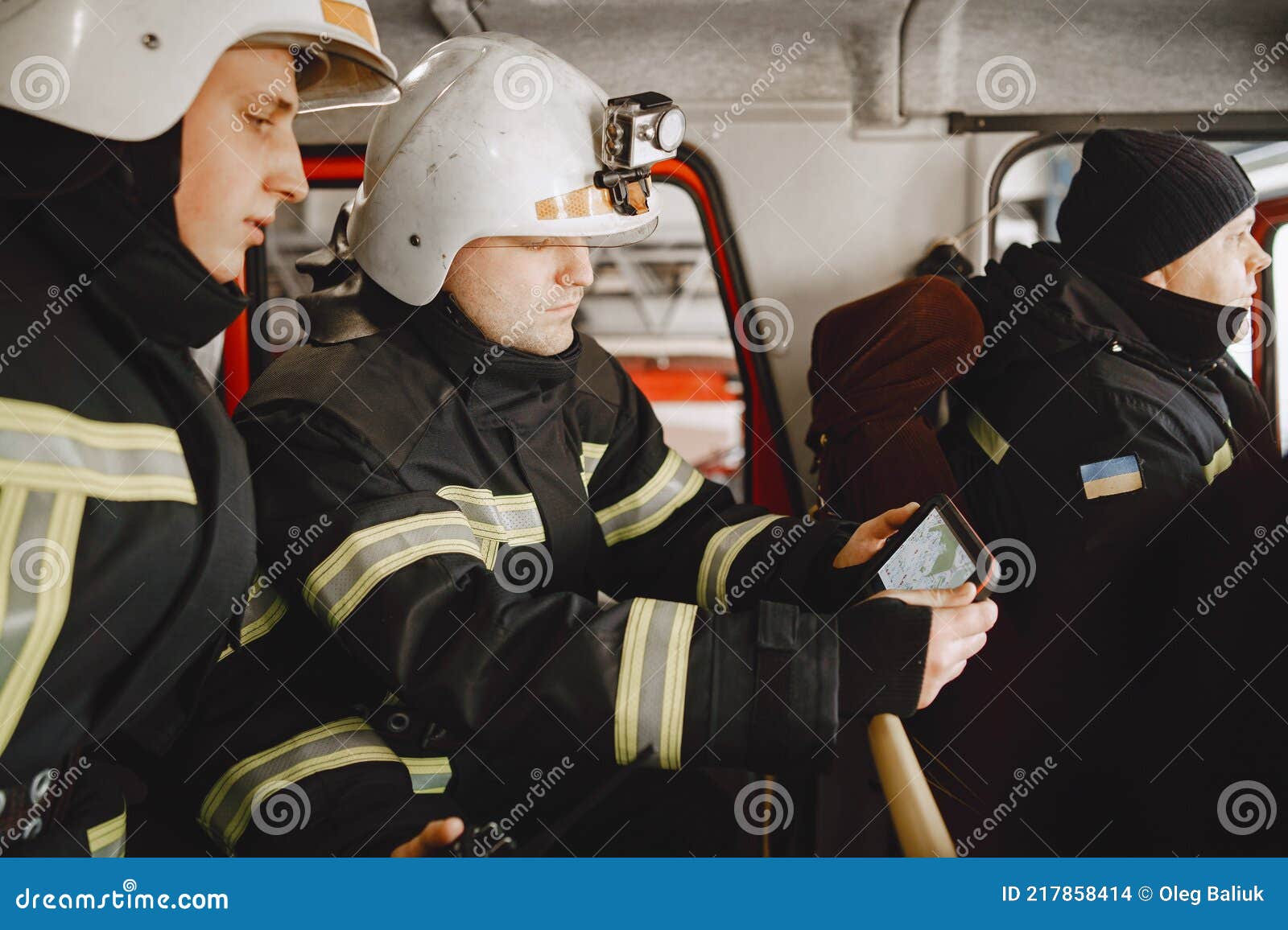 Firefighters in a Fire Truck Look at Tablet Stock Photo - Image of ...