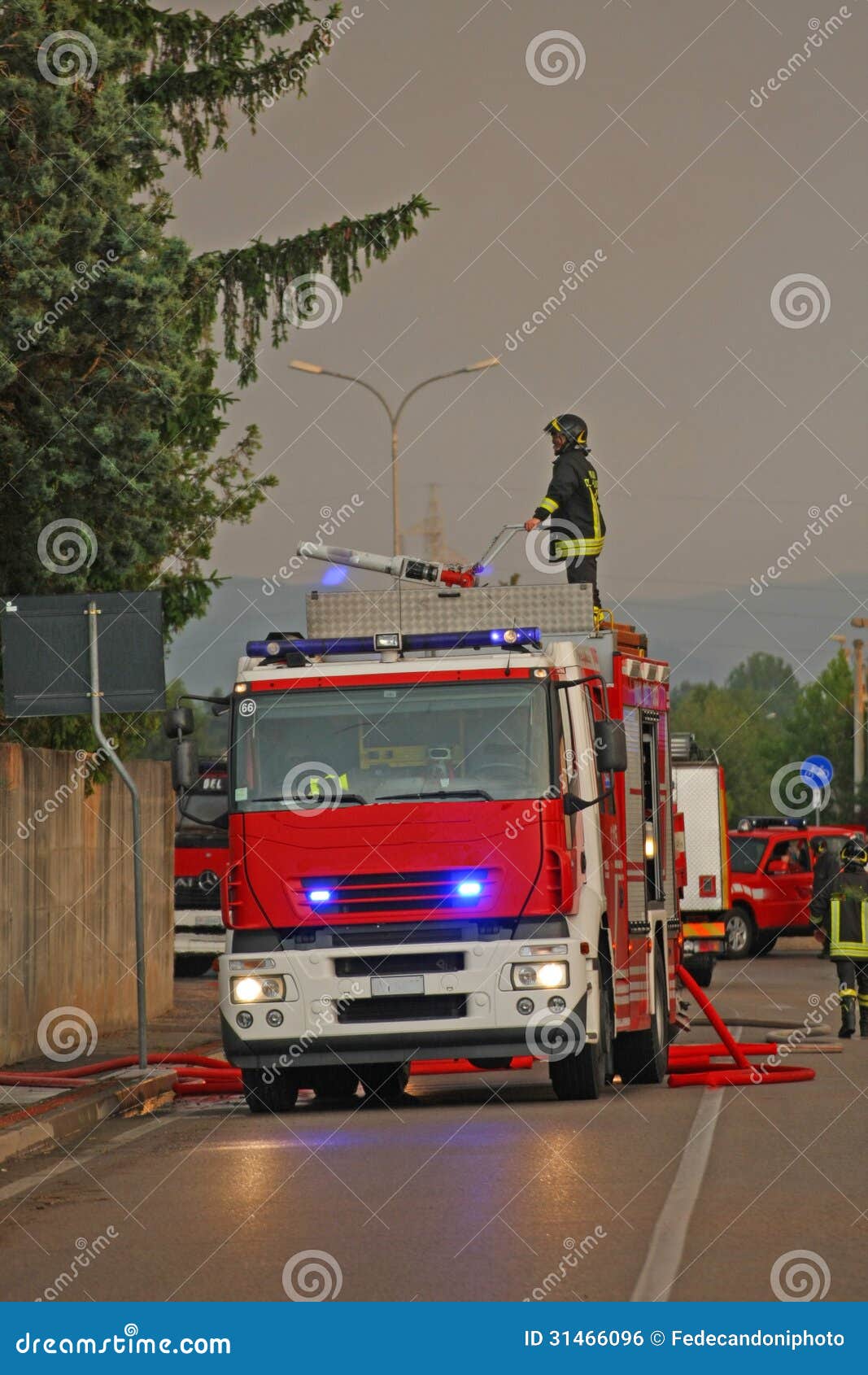 Firefighters with the Fire Truck when Switching Off a Fire Stock Photo ...