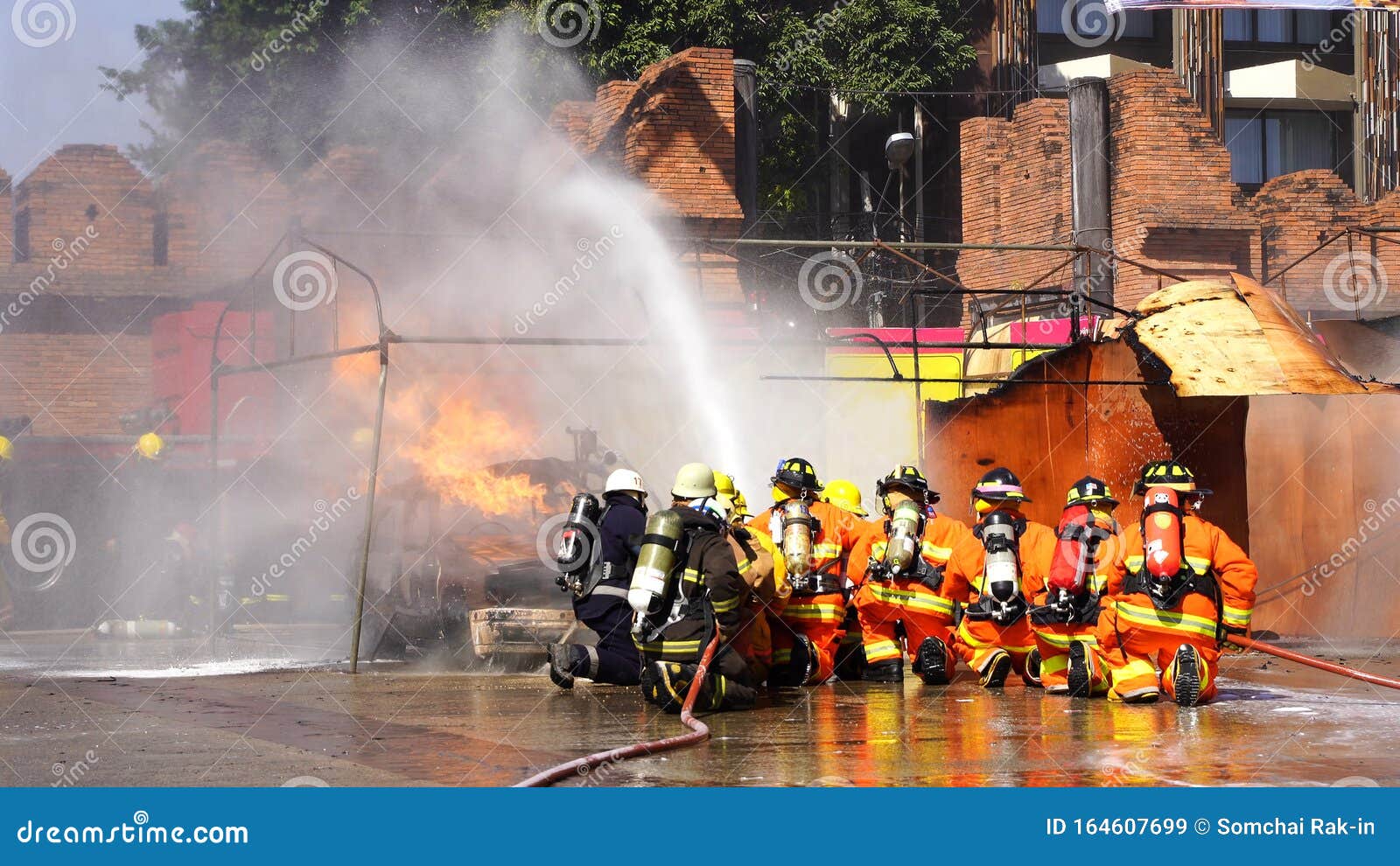 Firefighters in Fireproof Uniform Fighting a Fire and Spraying High ...