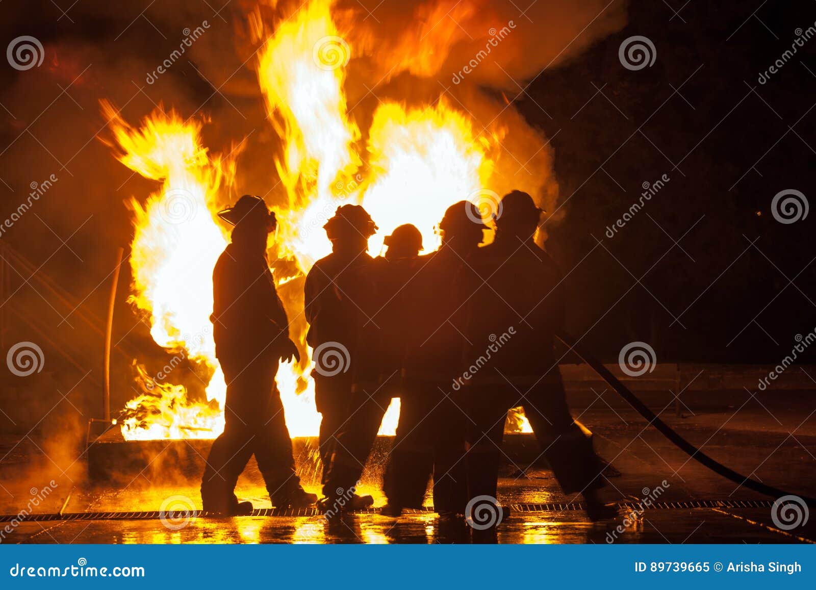 Firefighters Hosing Down Burning Tank Durning Firefighting Exercise ...