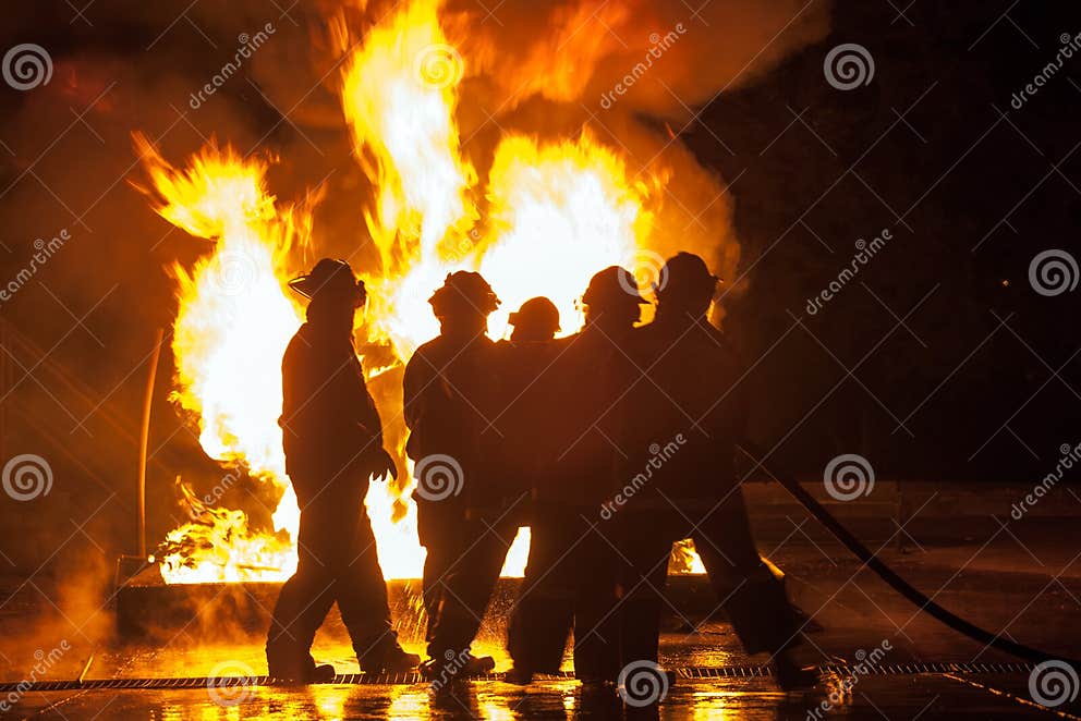 Firefighters Hosing Down Burning Tank Durning Firefighting Exercise ...