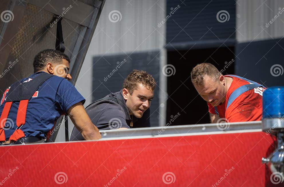 Firefighters Loading Hoses Onto Fire Engine Editorial Photography ...