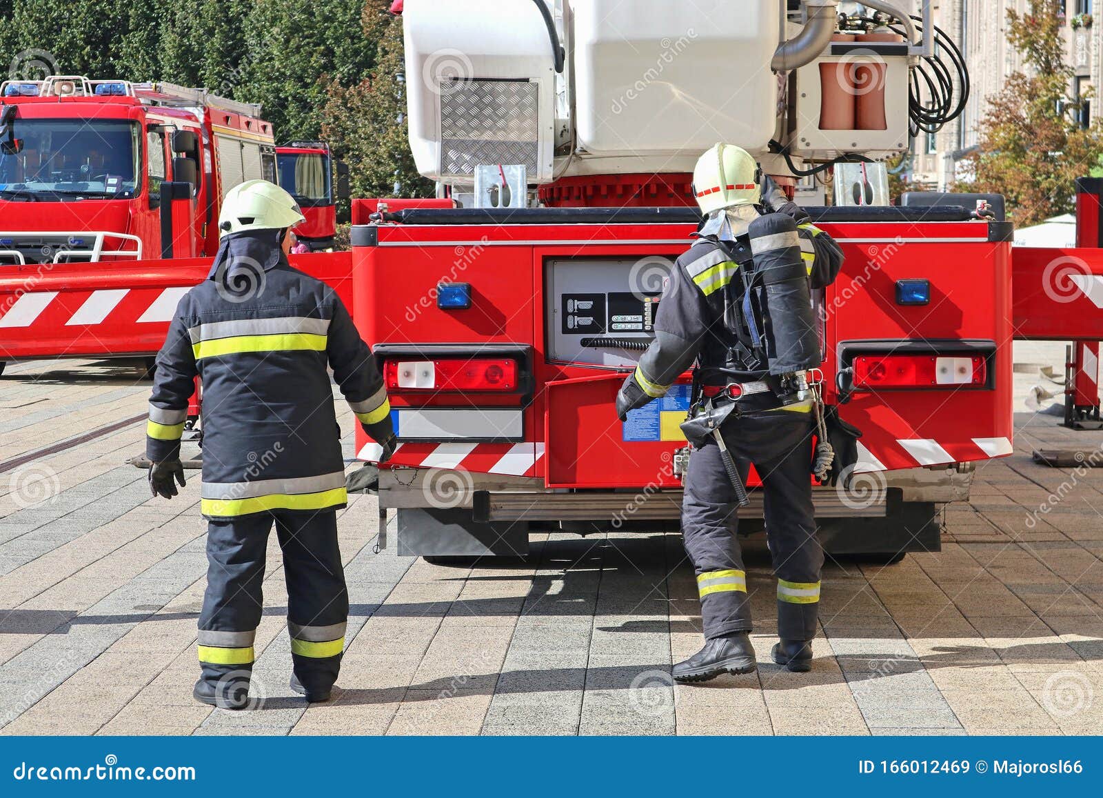 Firefighters Next To a Fire Truck Stock Image - Image of reflective ...