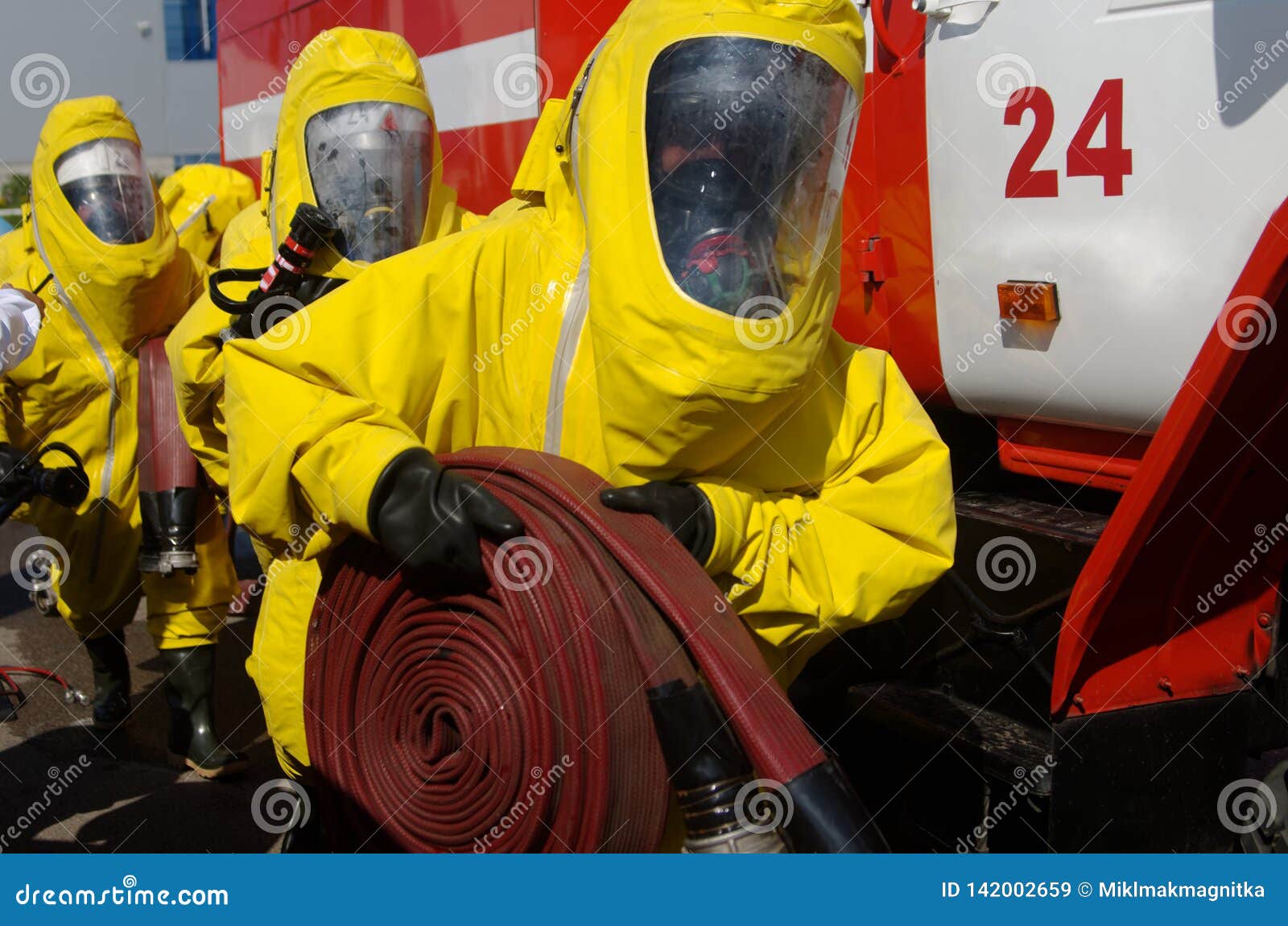 Firefighters in Protective Suits, Gas Masks and a Hose are Getting ...