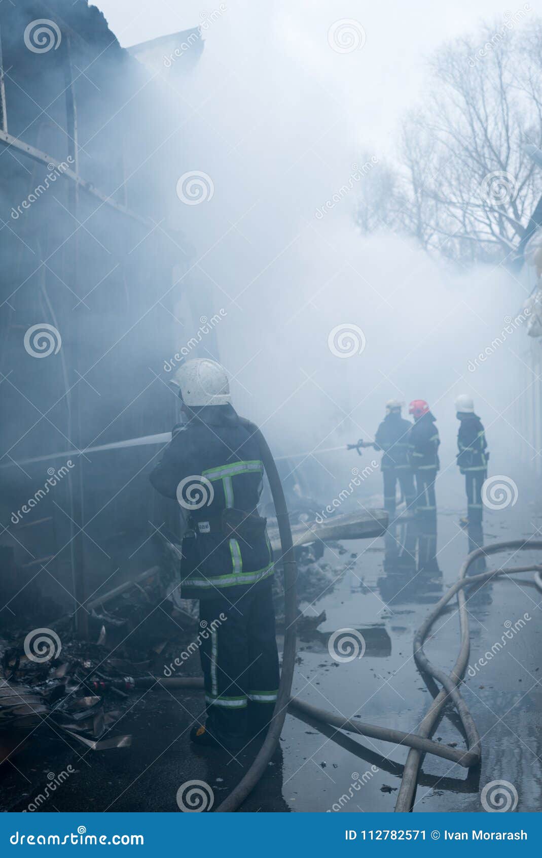 Firefighters Spray Water. Smoke and Buiding after Fire Editorial Photo ...