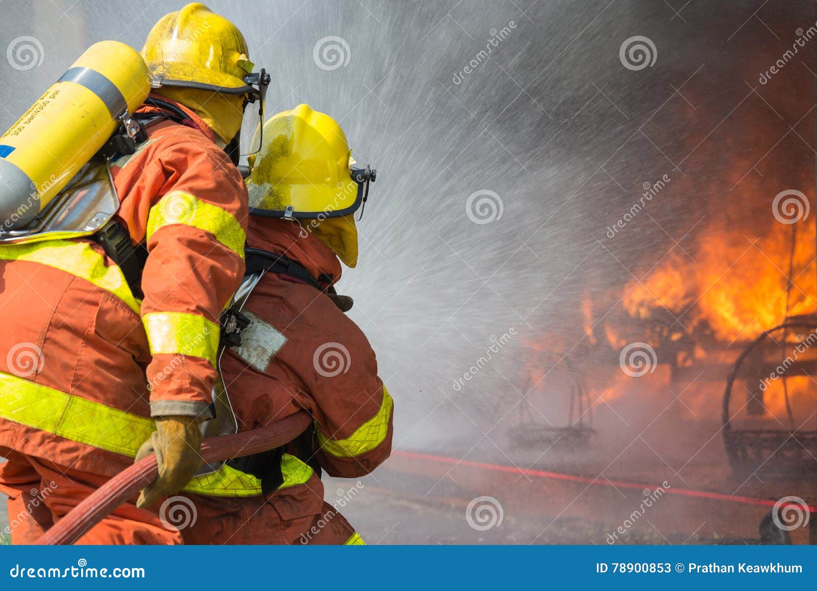 2 Firefighters Spraying Water in Fire Fighting Operation Stock Image ...