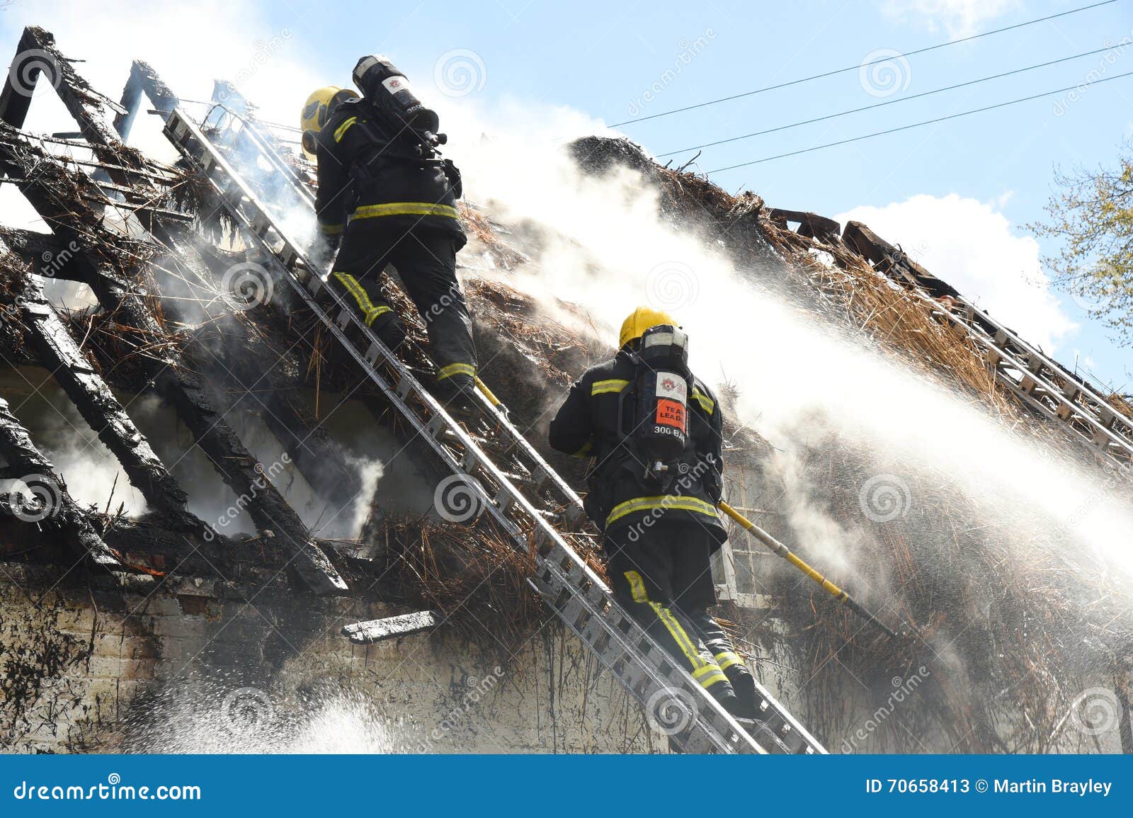 Firefighters Tackle A Fire On A Cottage Roof. Editorial Image ...