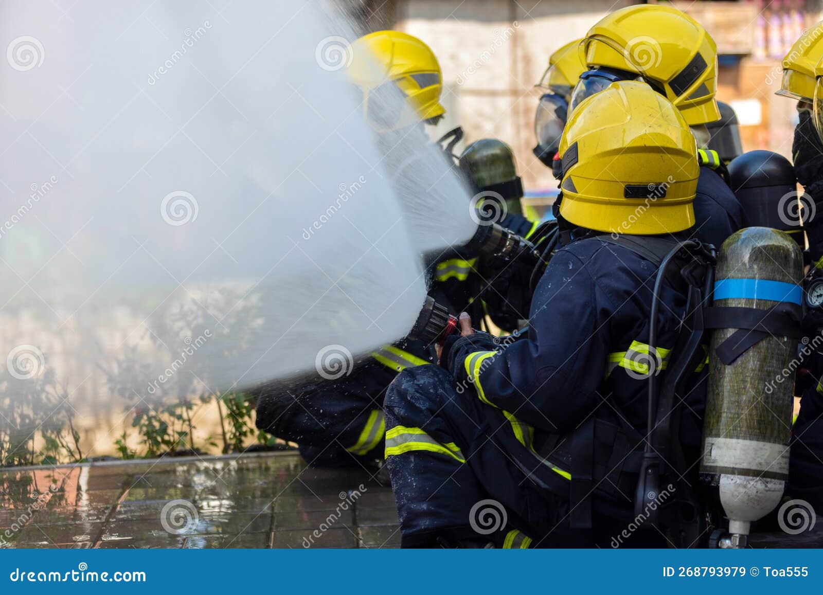 Firefighters Team Spray Water To Extinguishes a Fire Stock Image ...