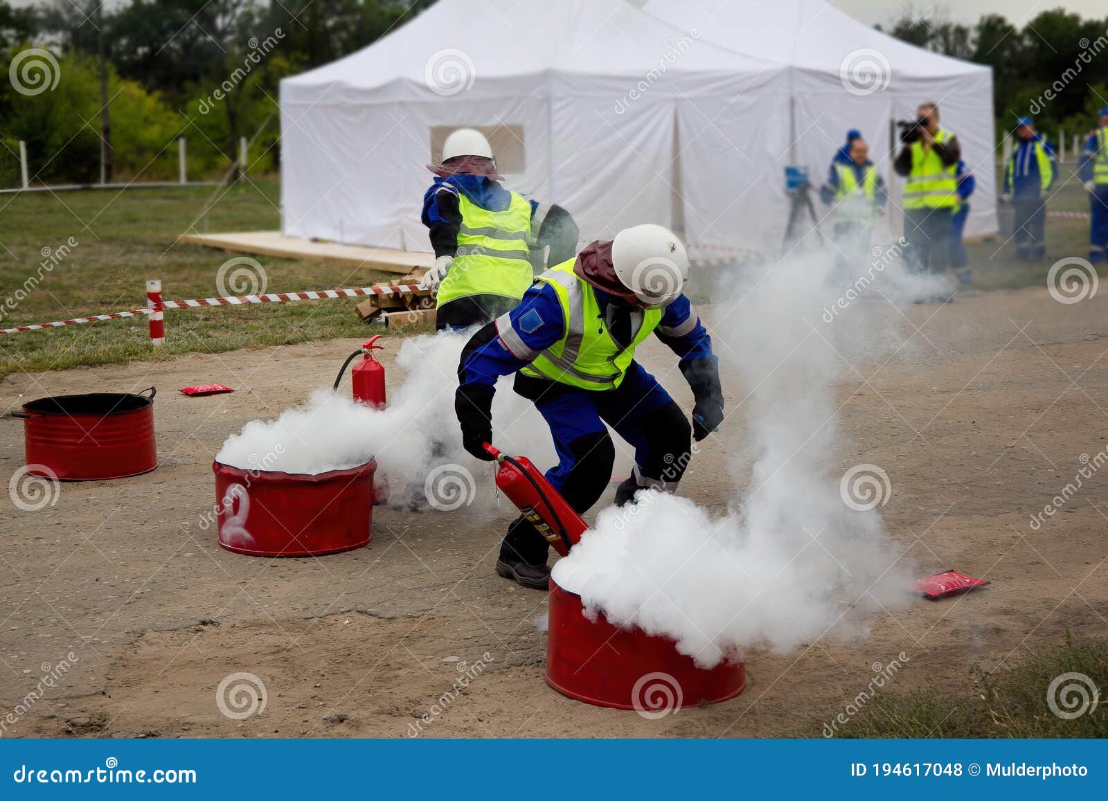 Firefighters on Training. Firemen Using Use a Fire Extinguisher on a ...