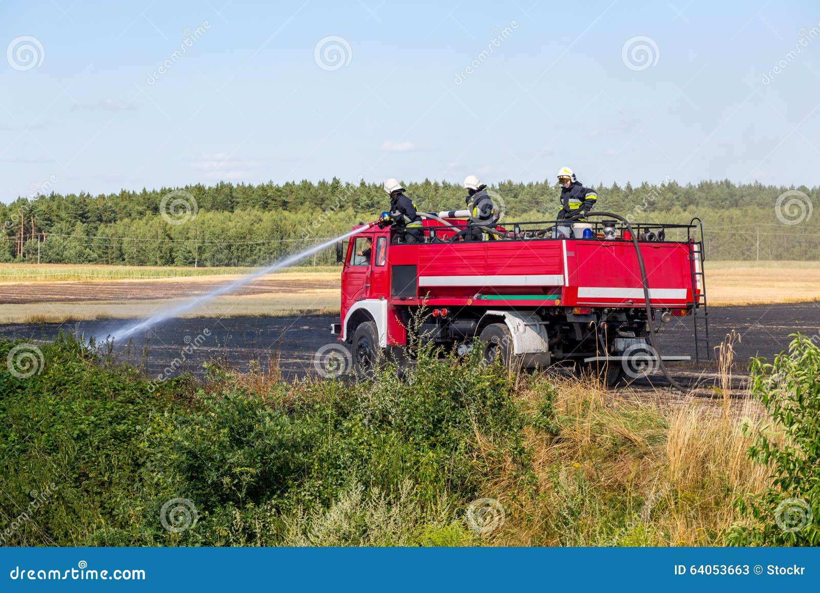 Firefighters Truck Working on the Field on Fire Stock Image - Image of ...