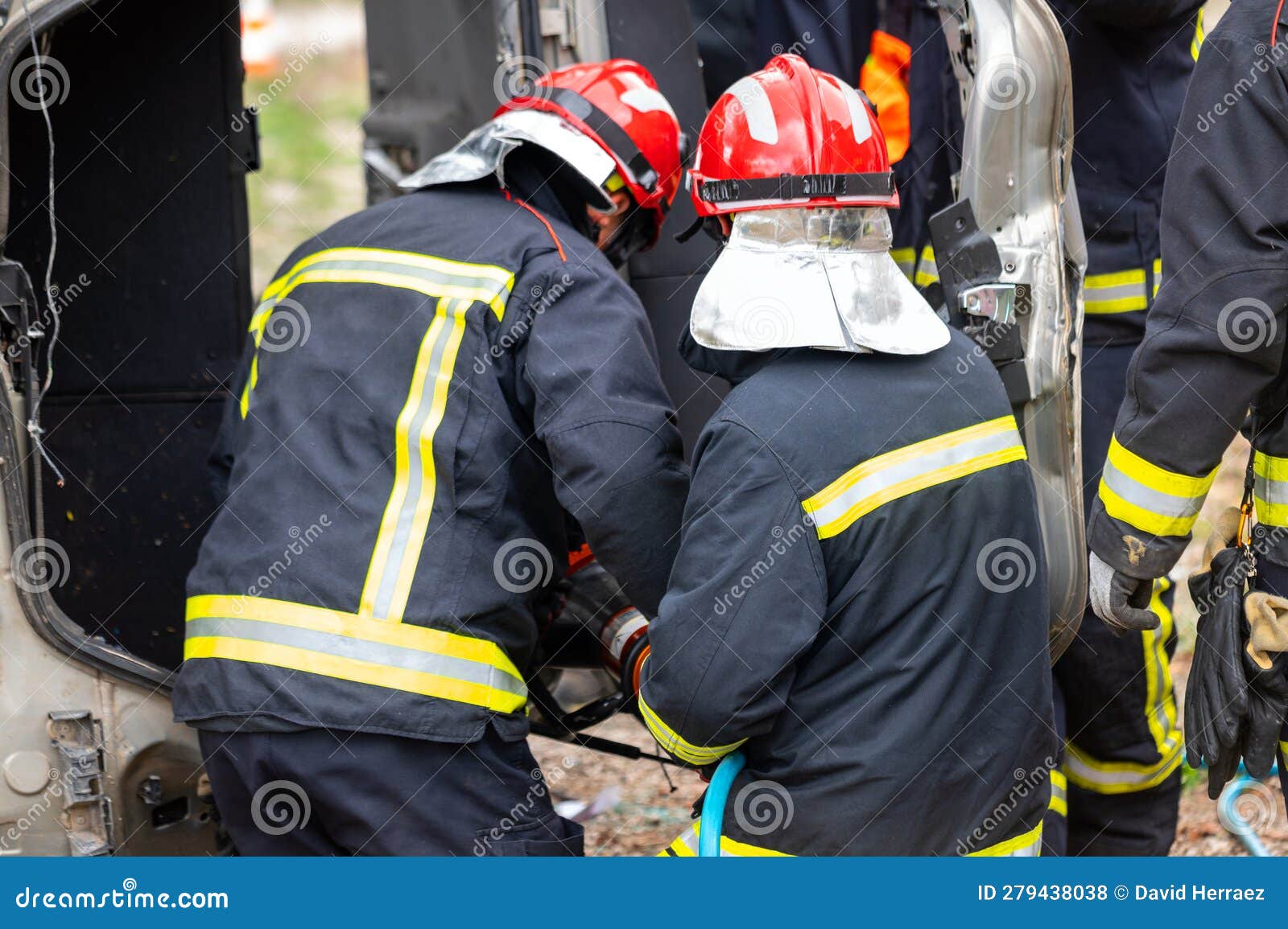 Firefighters Using Hydraulic Tools during a Rescue Operation Training ...