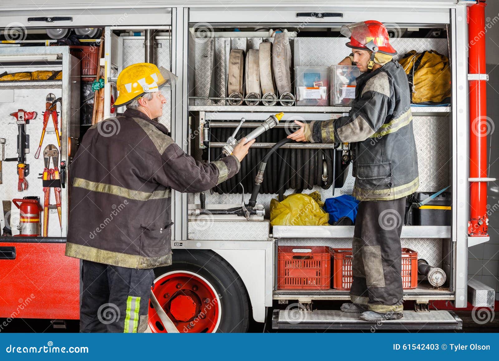 Firefighters Working at Truck in Fire Station Stock Image - Image of ...