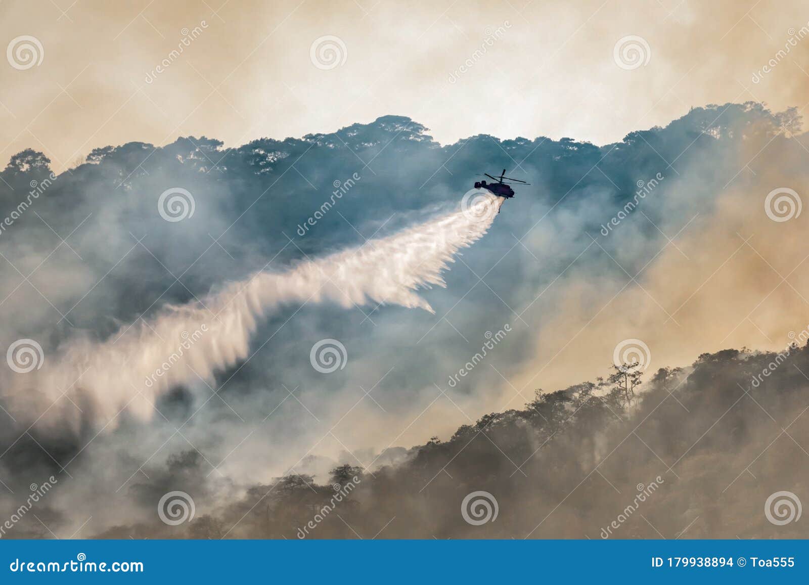 Firefighting Helicopter Dropping Water on Forest Fire Stock Photo ...