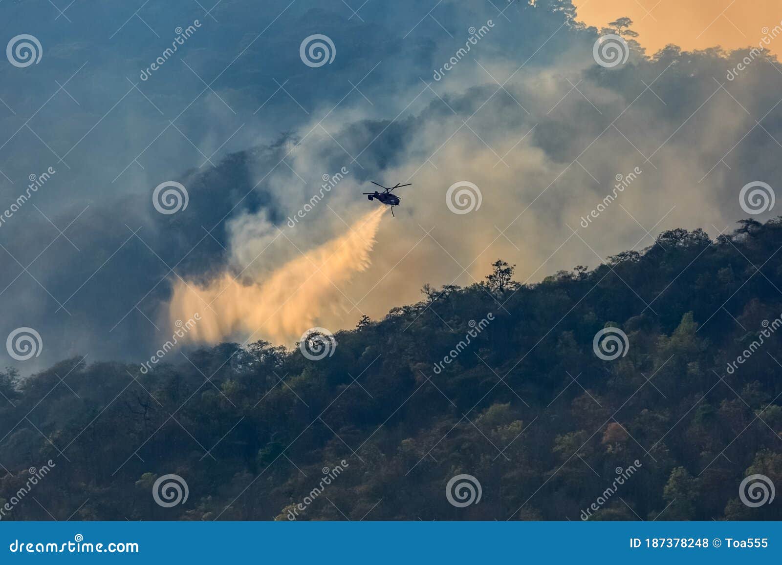 Firefighting Helicopter Dropping Water on Forest Fire Stock Photo ...