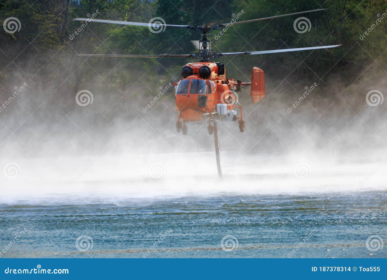 Firefighting Helicopter is Hovering Over the Pond To Refills Water ...