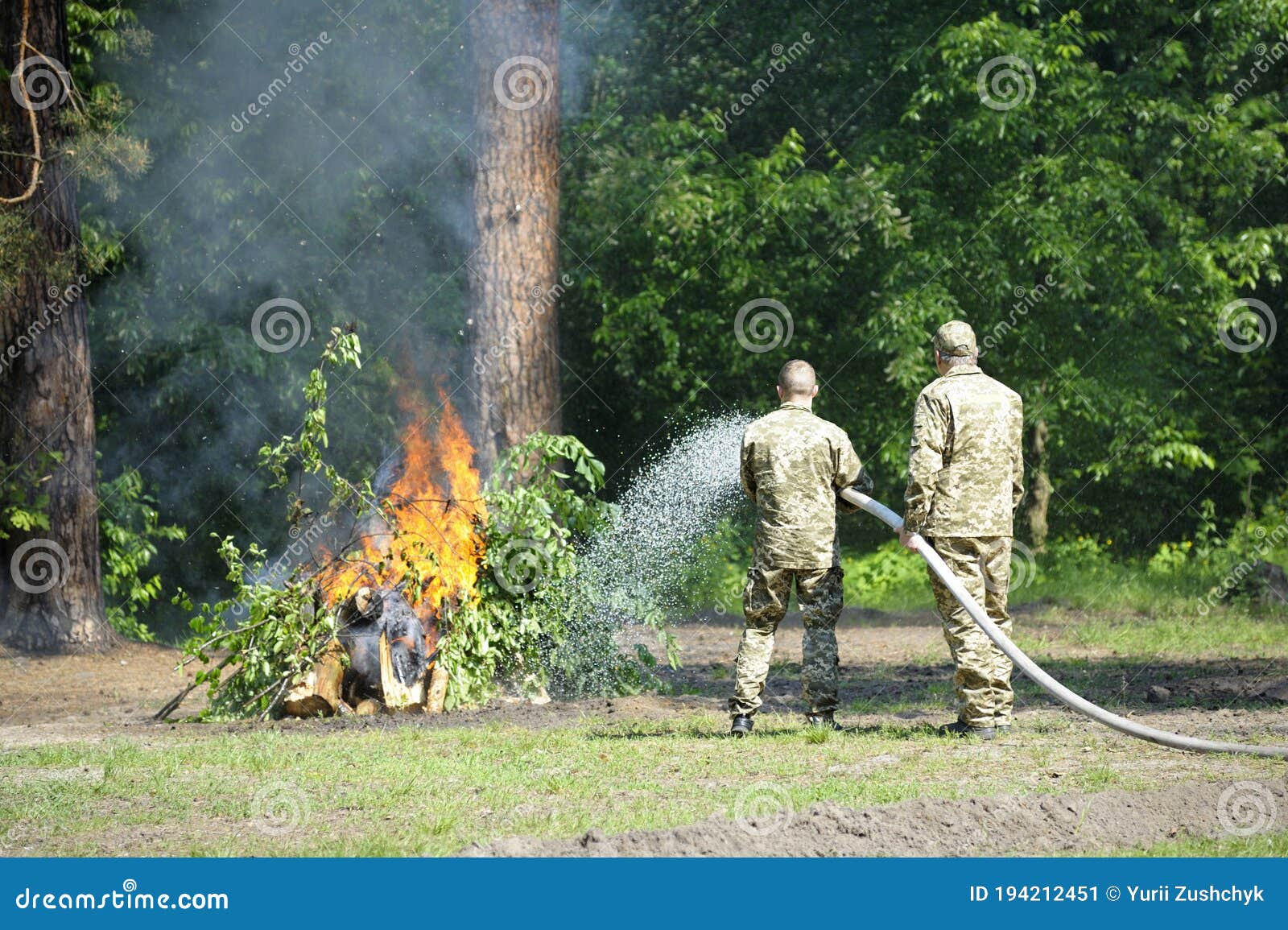 Firefighting Team Training: Firemen in Protective Ensembles Watering ...