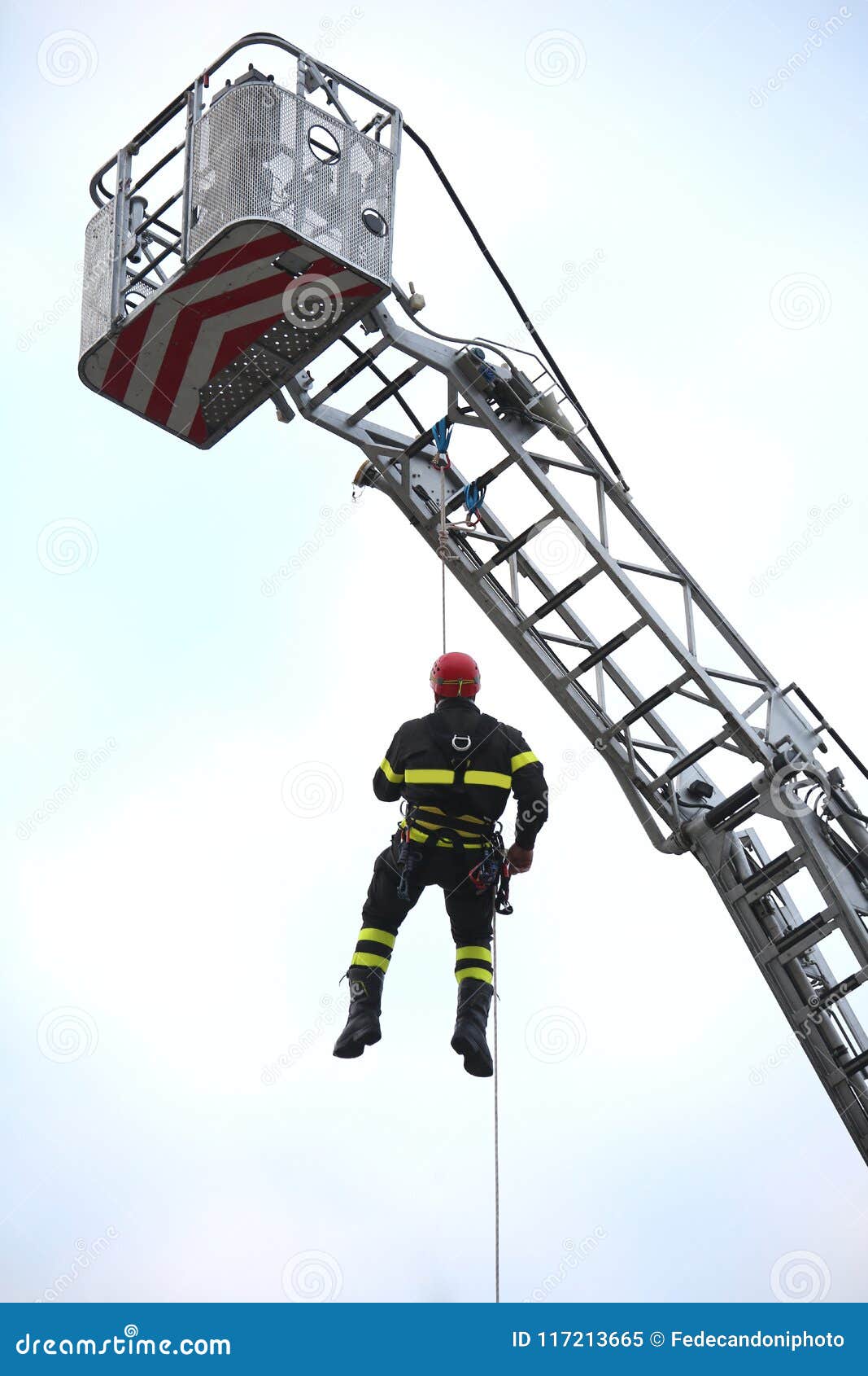 Fireman on action hanging stock image. Image of people - 117213665