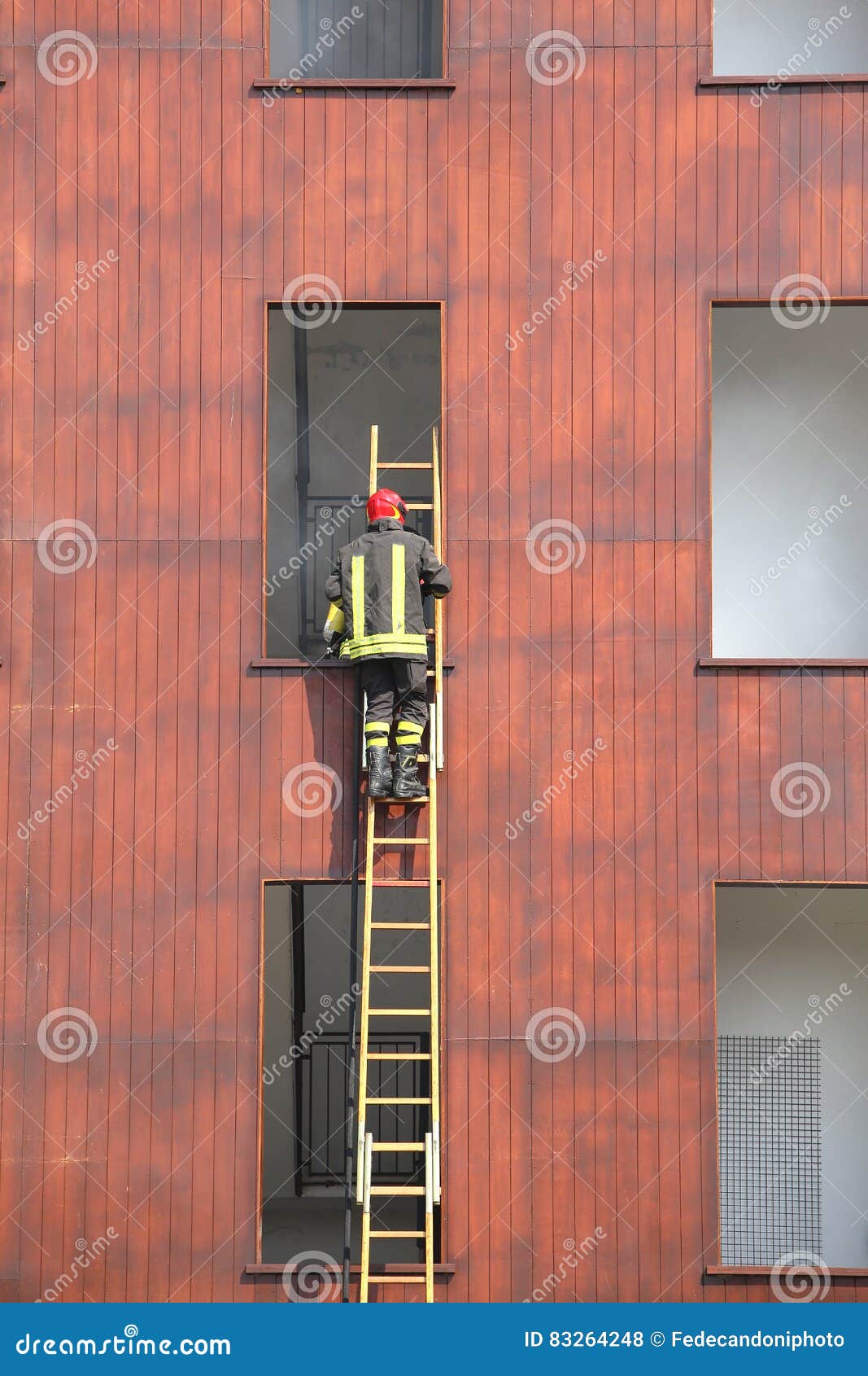 Fireman Climbs Up the Ladder during a Training Stock Photo - Image of ...