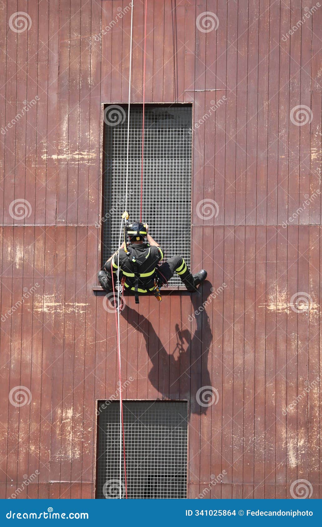 Fireman Descending from the House with the Double Rope Technique Stock ...